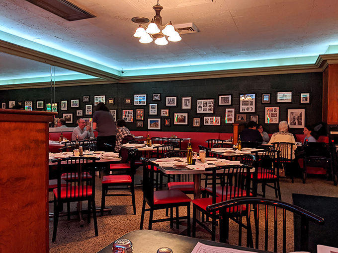 Red booths cradle diners like old friends while blue drinks add a pop of color to tables where food is the main character in everyone's story.