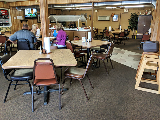Where strangers become friends over shared appreciation of smoke rings. The ceiling fans circulate not just air, but the intoxicating aroma of barbecue.