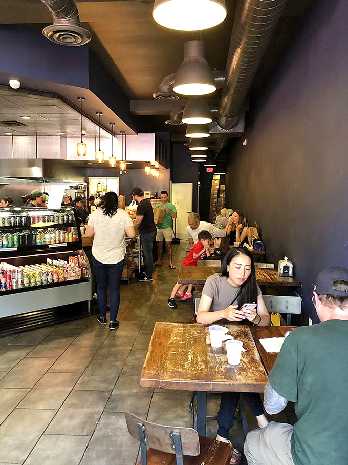 Lunchtime buzz creates the perfect symphony of conversation and satisfaction. Every table tells a story of sandwich-induced happiness.