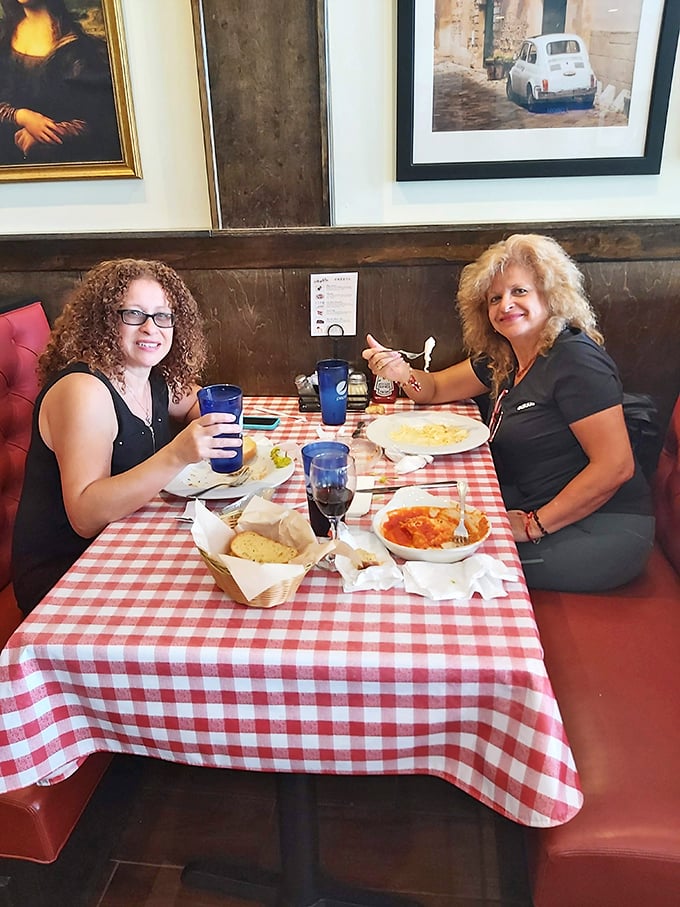Two satisfied diners sharing that "we made the right restaurant choice" smile. The bread basket's emptiness tells the whole story.