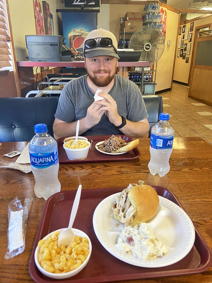 The universal language of barbecue satisfaction. Those trays of pulled meat and golden mac and cheese speak volumes about what matters here.