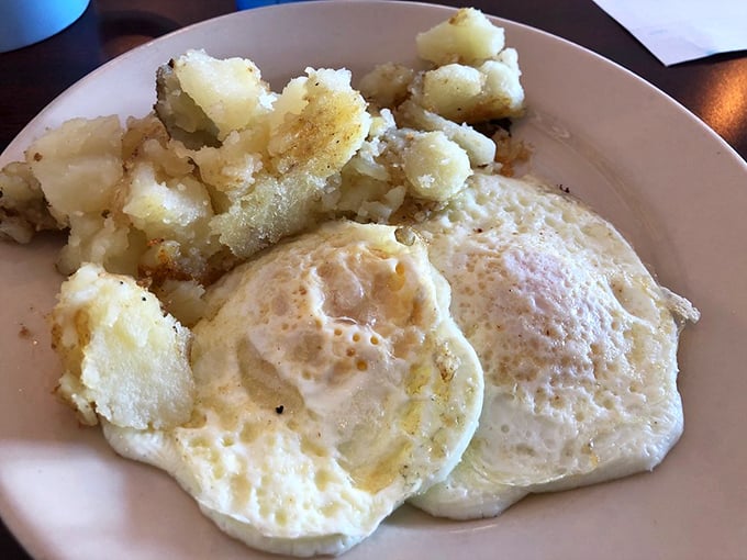 Simple pleasures done right: sunny-side up eggs with just-set whites and glorious runny yolks next to potatoes that have been introduced to a proper hot griddle.