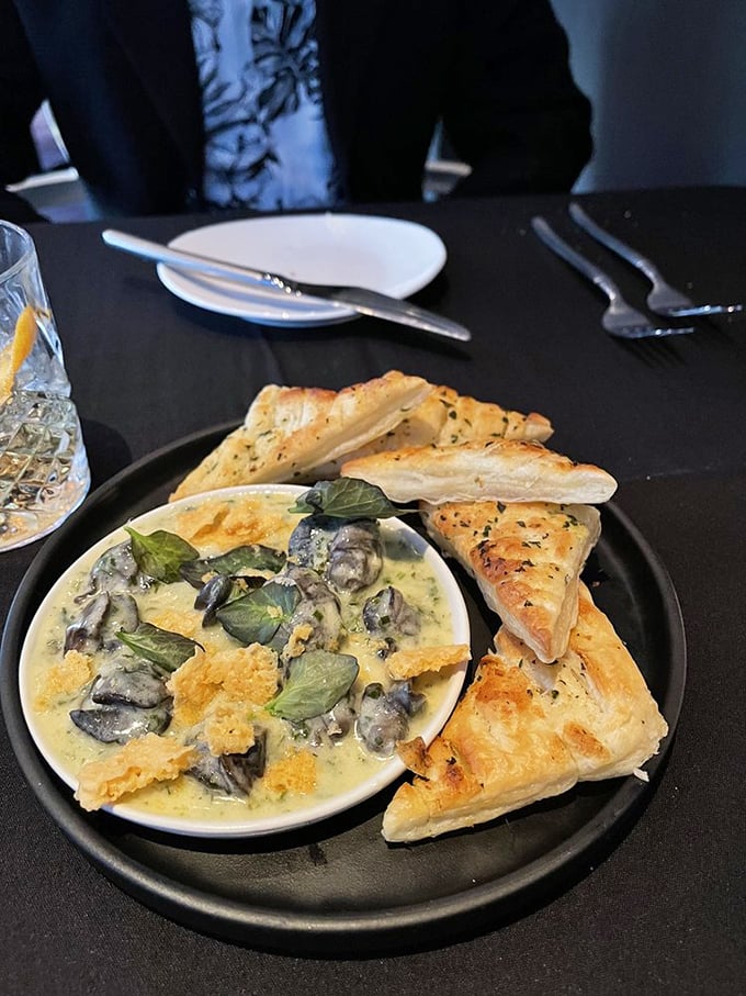 Escargot gets the royal treatment, swimming in a creamy sauce with perfectly toasted bread for dipping. Fancy meets comfort food.