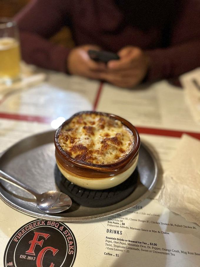 French onion soup that's having an identity crisis as a hot tub for cheese. The stretchy, gooey crown makes each spoonful a theatrical event.
