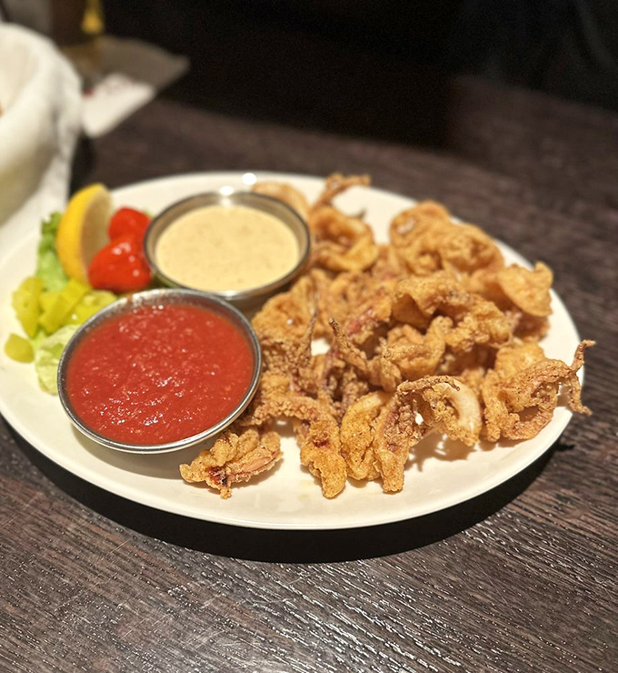 Golden-fried calamari with two distinct dipping options—one zingy, one creamy. This is the appetizer equivalent of bringing two dates to the same party.