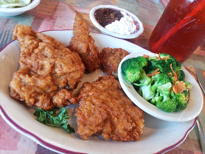 Fried chicken that achieves the impossible balance of crispy exterior and juicy interior, paired with broccoli that's actually worth eating. 