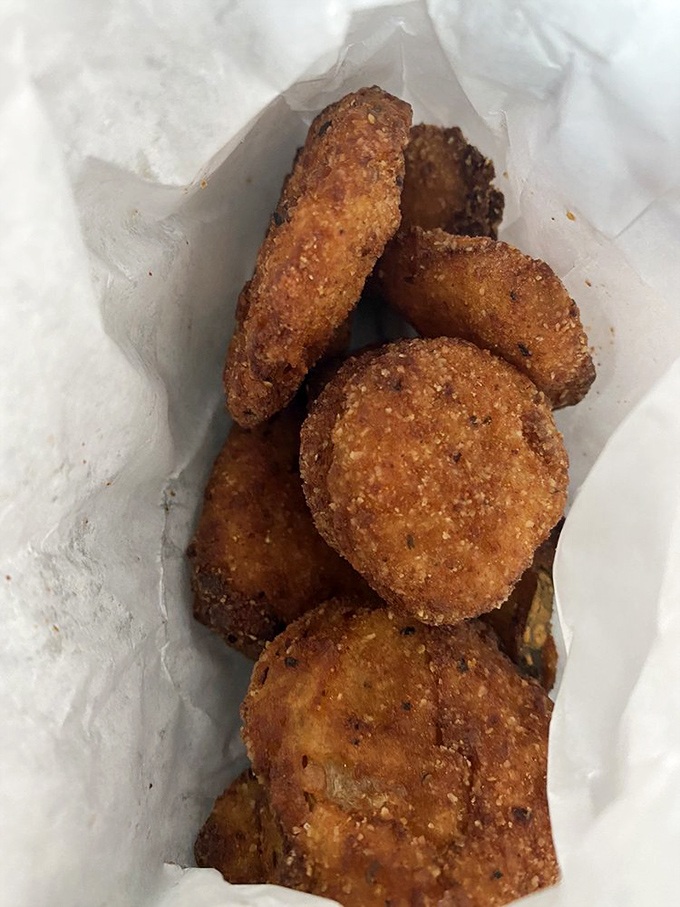 Fried pickles&mdash;where tangy meets crunchy in a paper bag of addictive contradiction. The perfect sidekick to any burger adventure.