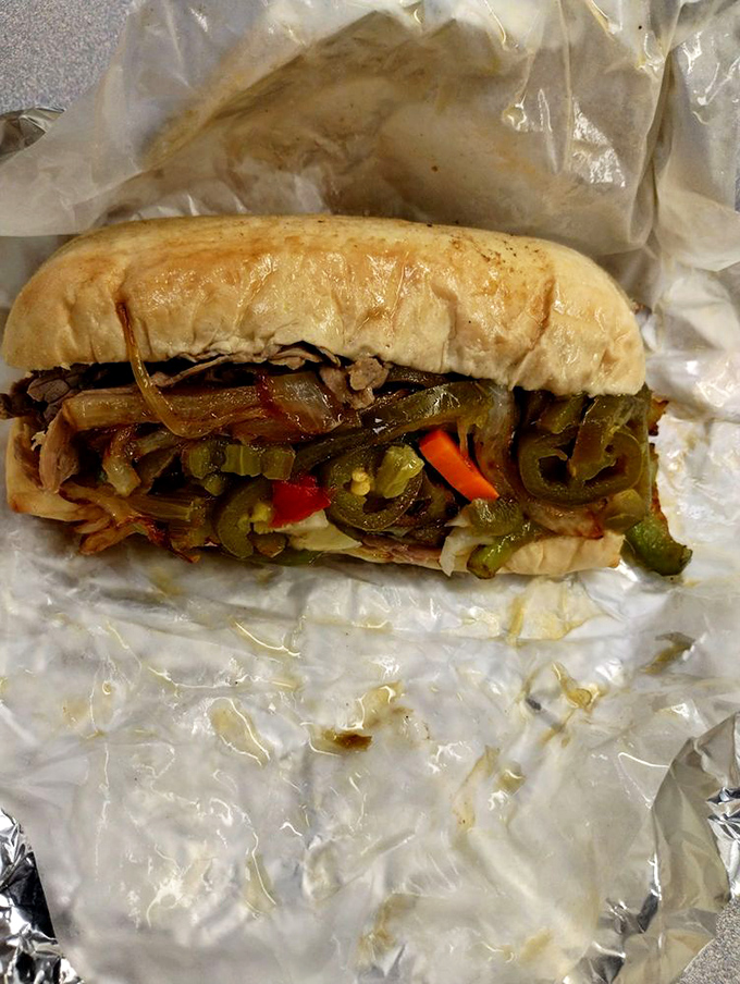 This Italian beef sandwich looks like it just stepped off a Chicago street corner, peppers and all, ready to make a serious impression on your hunger situation.