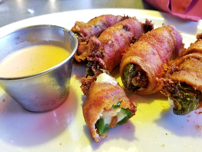 Bacon-wrapped jalape&ntilde;o poppers: where heat meets sweet meets meat. The appetizer equivalent of a country music power ballad.