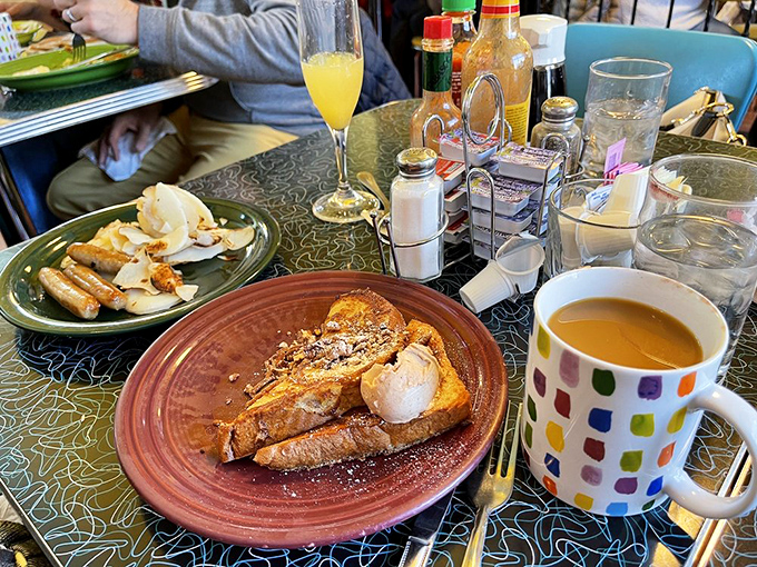 French toast that looks like it's auditioning for a magazine cover, paired with a colorful mug that makes chain coffee shops look positively bland.
