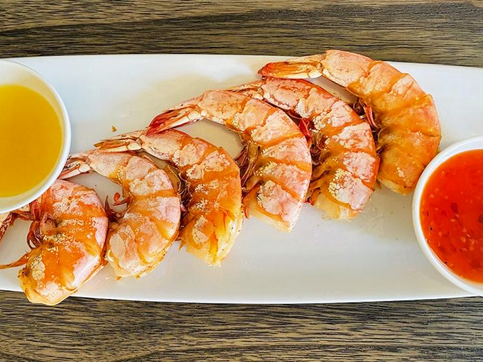 These jumbo prawns are so perfectly cooked they could make a vegetarian question their life choices. The dual dipping sauces? Pure genius.