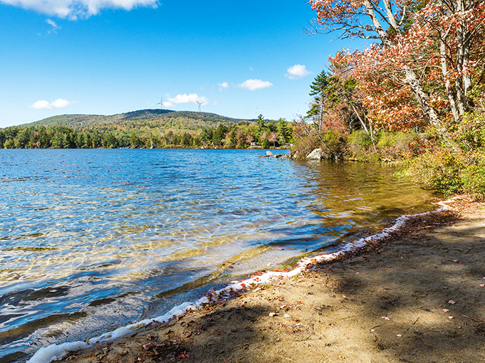 Beach day, New Hampshire edition: crystal clear waters meet golden sand, with mountains standing guard. No crowds, no noise&mdash;just pure bliss.