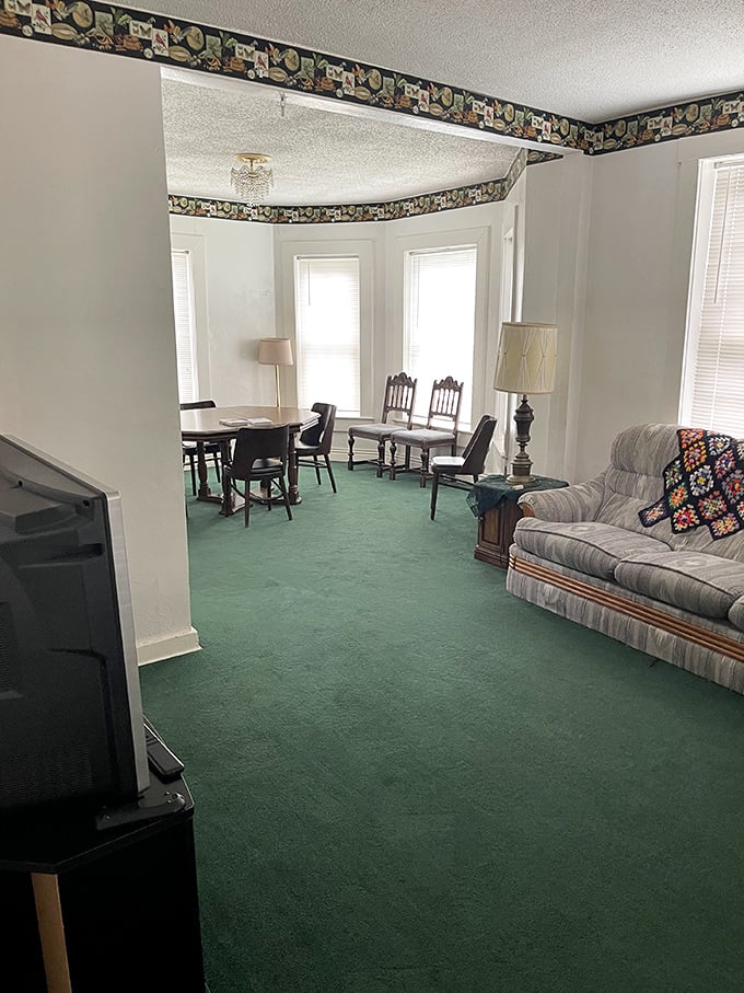 The living room's bay windows and vintage furniture offer a comfortable space for ghost hunting&mdash;or becoming part of the haunted history yourself.