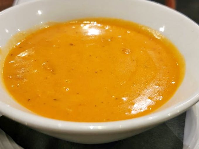This lobster bisque glows with the amber promise of flavor that's been coaxed from shells, herbs, and patience. Each spoonful is like a warm ocean embrace.