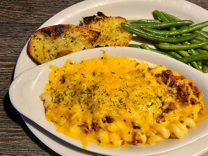 Mac and cheese that's achieved celebrity status—all golden, bubbling, and ready for its close-up with those perfectly seasoned green beans.
