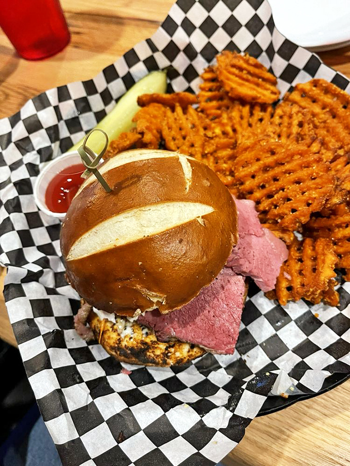 The Montreal corned beef sandwich on a pretzel bun with waffle fries is what happens when Canada and Florida have a delicious love child.
