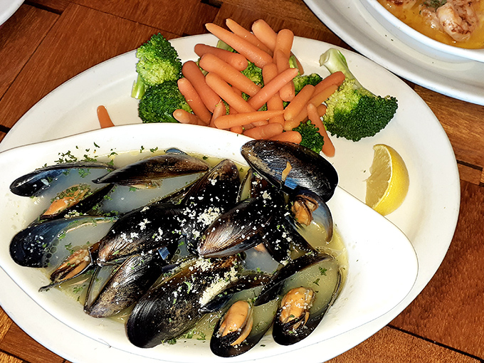 These mussels aren't just swimming in garlic butter &ndash; they're doing the backstroke in it. The vibrant vegetables provide a colorful lifeguard duty.