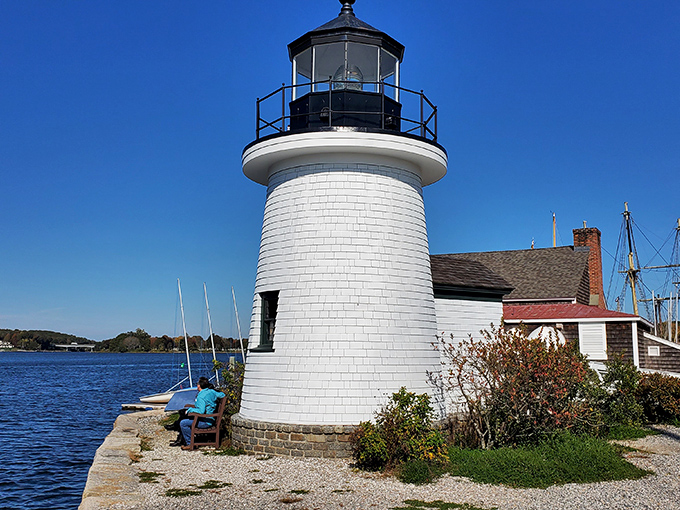 Mystic Seaport Light stands sentinel over the harbor, a postcard-perfect reminder of when these waters guided America's maritime destiny.