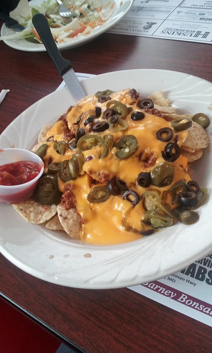 Nachos that require a strategy to eat and a nap afterward. Every chip is a treasure hunt for the perfect combination of toppings.