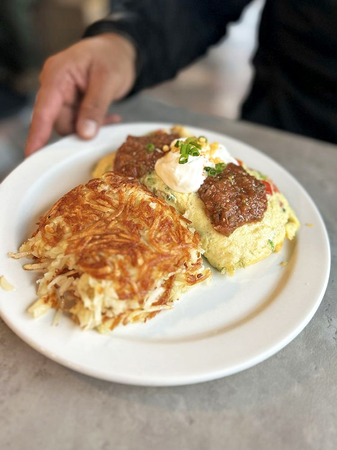 French toast and ham steak sharing a plate like old friends, while that sunny-side egg watches over everything. Morning perfection on white porcelain.