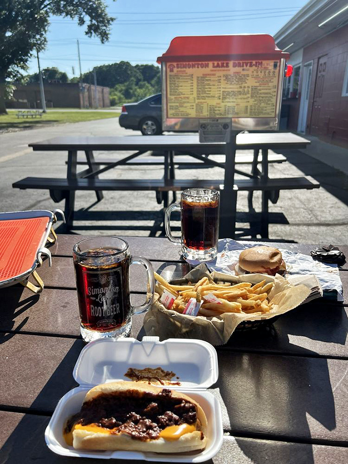 Al fresco dining, drive-in style! Those picnic tables have heard more family stories than a therapist on a busy Monday.