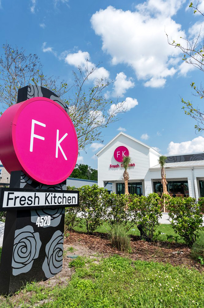 The roadside sign announces your arrival at flavor town with that signature magenta circle&mdash;like a bullseye for your hunger.