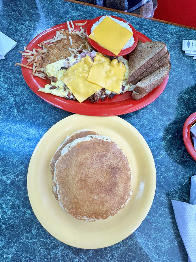 Upstairs: an omelet wearing a cheese blanket. Downstairs: pancakes tanned to golden perfection. This is breakfast's perfect power couple.