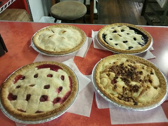Pie paradise! Four different fruit-filled wonders cooling on the counter. Grandmothers everywhere are nodding in approval at these picture-perfect crusts.