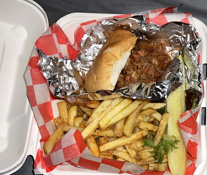 The holy trinity of lunch: pulled pork, fresh-cut fries, and a pickle. This sandwich is what happens when bar food gets baptized in flavor.