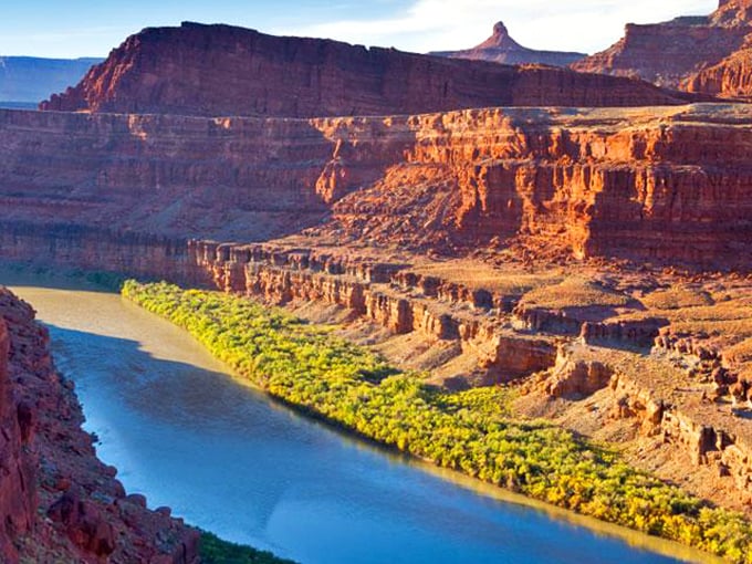 The Colorado River carves its masterpiece through canyon country—a ribbon of life bringing greenery and adventure to the desert.