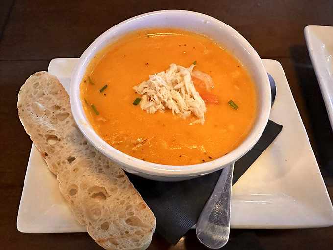 A seafood bisque so velvety it could moonlight as a spa treatment. The bread alongside knows it's just there for the ride.