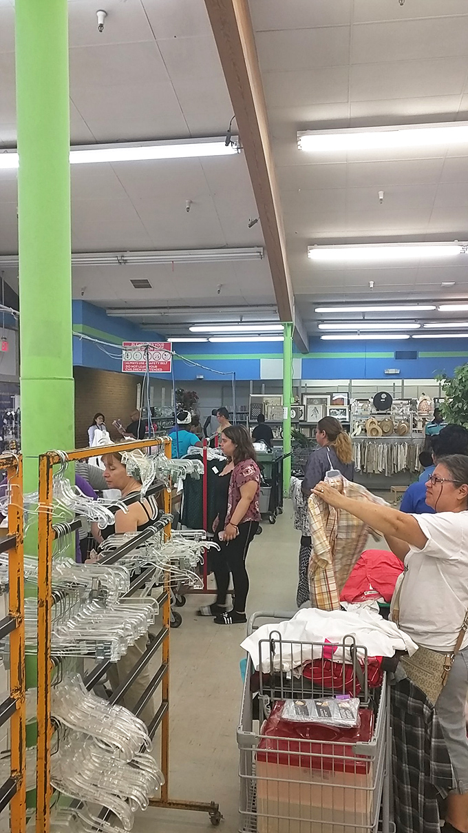 Serious shoppers in their natural habitat. Notice the focused expressions and strategic cart positioning&mdash;these are not amateurs at the thrifting game.