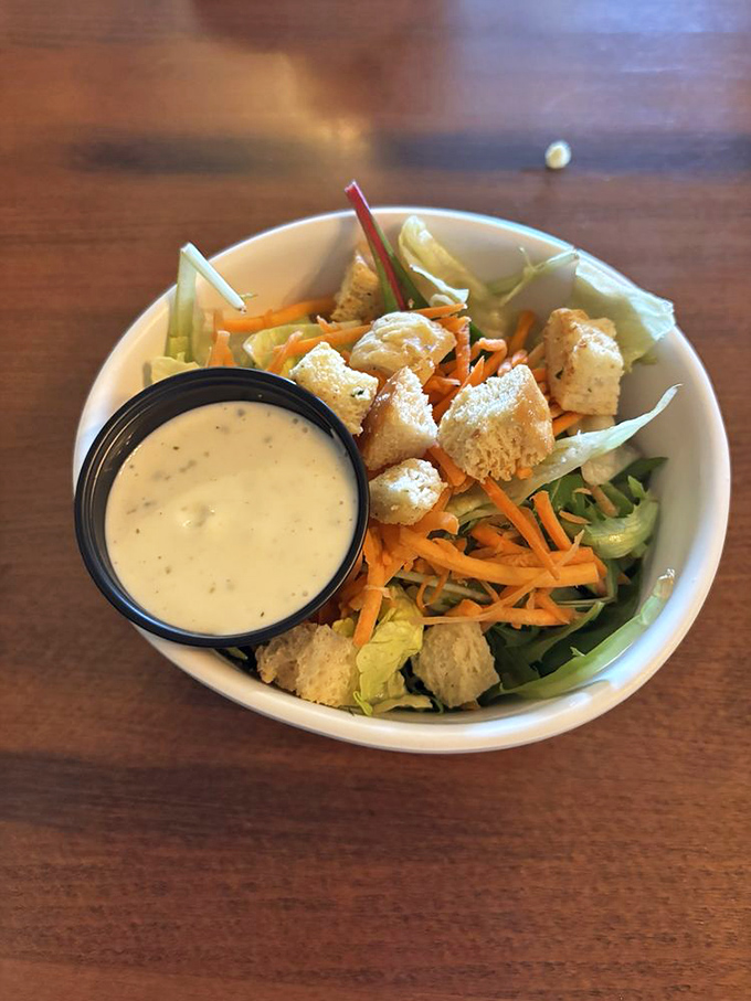 A side salad that actually deserves attention, with house-made croutons that didn't come from a bag with an expiration date from 2025.