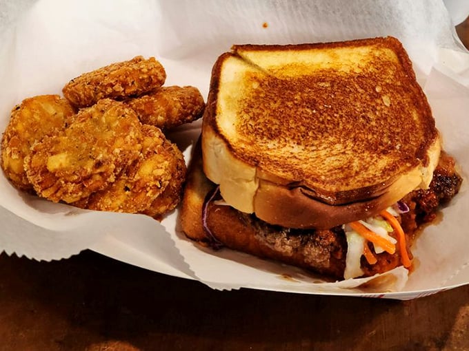 This burger has the structural integrity of a well-engineered bridge, but with coleslaw threatening delicious chaos with every bite.