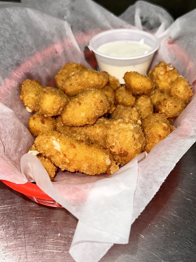 These golden-fried cheese curds deserve their own Instagram account. Crunchy exterior, melty interior, and a dipping sauce worth bottling.