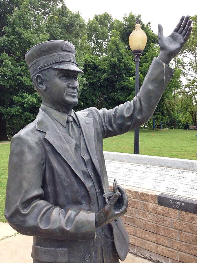"Welcome to Cotter," says this bronze gentleman without speaking a word. His permanent wave has outlasted countless Arkansas summers.