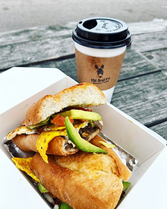 This isn't just a sandwich - it's breakfast architecture with avocado, bacon, and egg creating a structurally sound flavor palace.