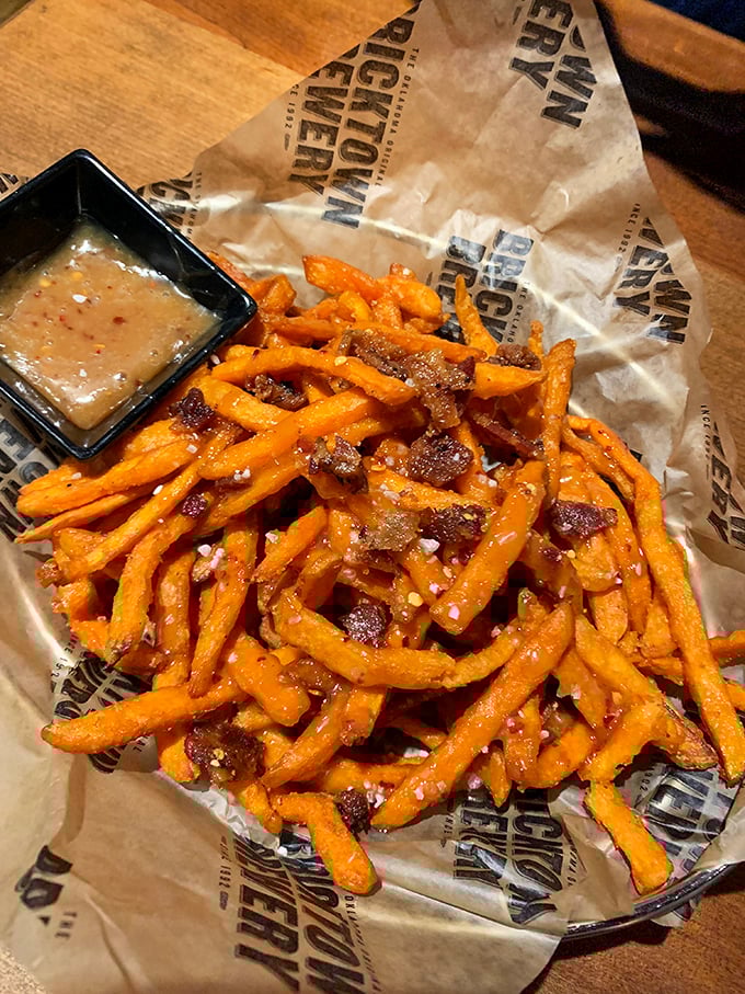 Sweet potato fries that have achieved the impossible: crispy exterior, pillowy interior, and seasoning that makes you wonder why regular fries get all the attention.