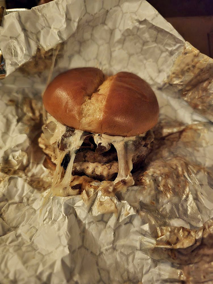 This burger's melty cheese situation is approaching national emergency status. Wrapped in foil like the precious treasure it truly is.