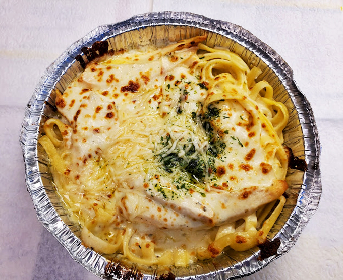 This fettuccine Alfredo is what clouds must taste like if they were made of cream, cheese, and carbohydrate dreams. Heaven in an aluminum pan.