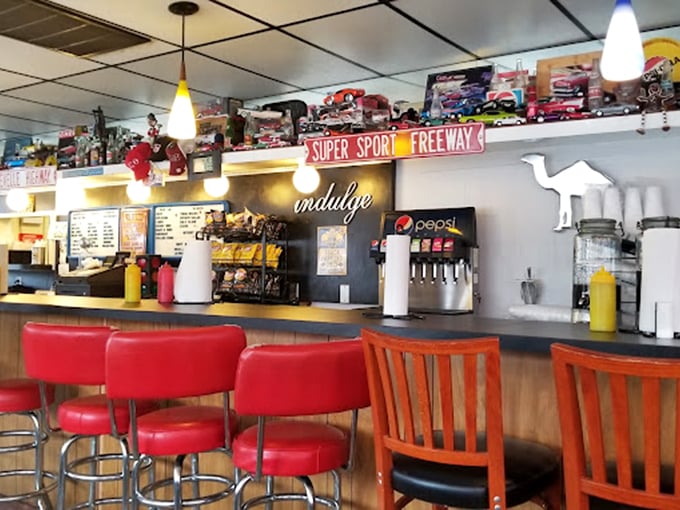 Red stools at the counter aren't just seating&mdash;they're front-row tickets to the best meat show in town. Note the camel silhouette watching approvingly.