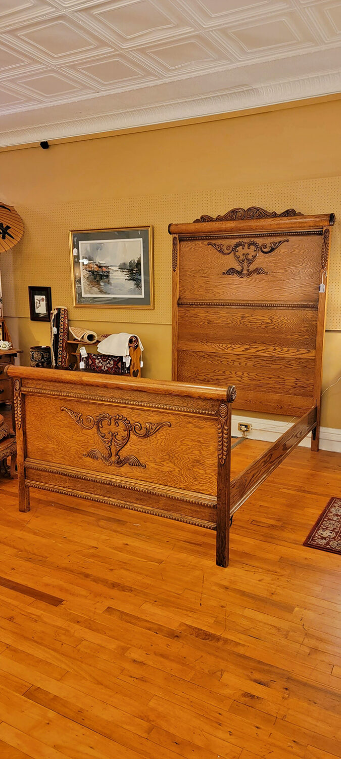 This oak bed frame with intricate carvings wasn't just furniture&mdash;it was a family heirloom built to last generations. 