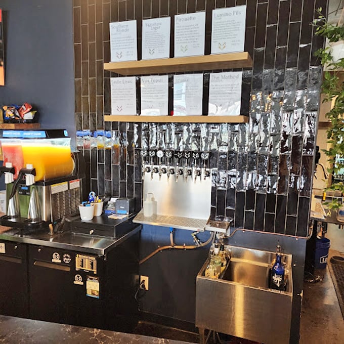 Gleaming taps lined against striking black tile—each one a portal to liquid craftsmanship waiting to fill your glass.