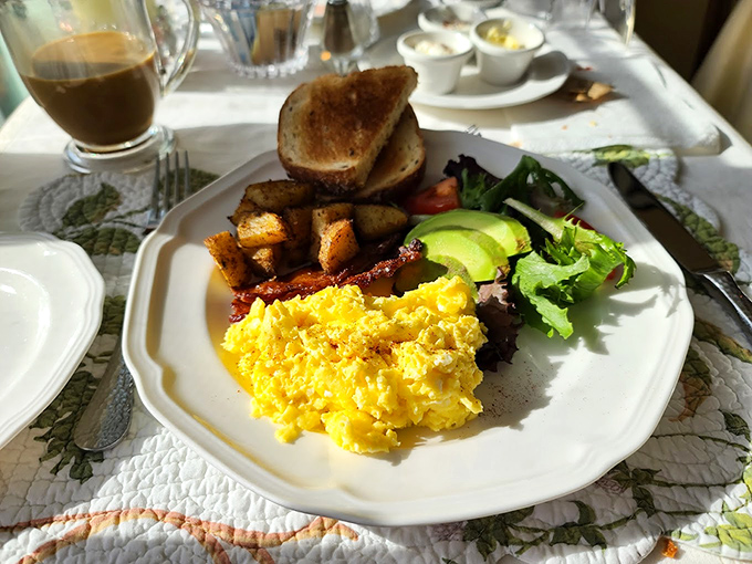 Breakfast of champions: Golden eggs, perfectly crisped potatoes, and fresh avocado create a plate that says "good morning" with more enthusiasm than you can muster pre-coffee.