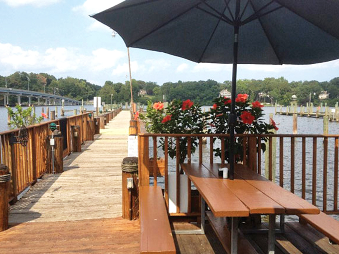 Waterfront dining with a view that turns every meal into an occasion—wooden picnic tables that have hosted countless crab feasts.