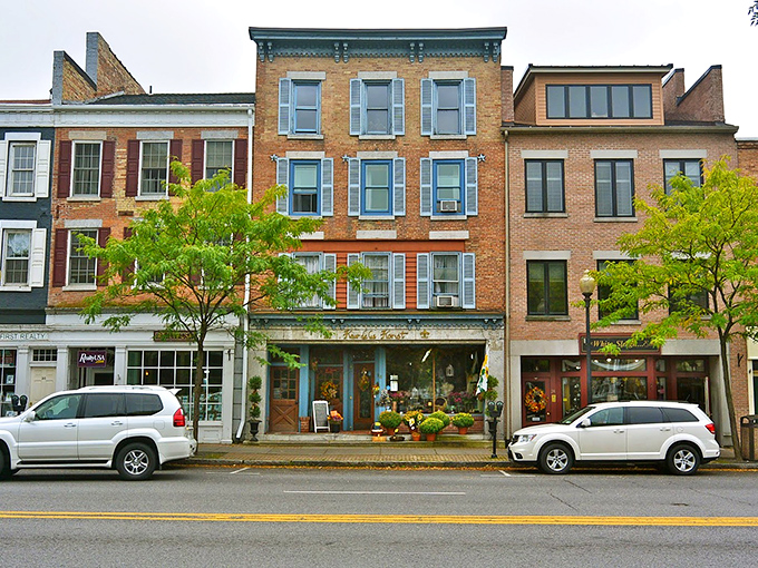 Rain-kissed storefronts gleam with promise, their window displays showcasing everything from artisanal chocolates to locally-crafted treasures.