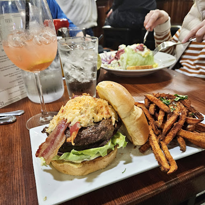 A tower of temptation where beef, bacon, and molten cheese create the skyscraper of satisfaction that ruins diets but builds memories.