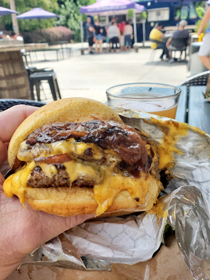The cheeseburger that makes you forget your table manners. When cheese stretches like this, photography becomes mandatory before the first bite.