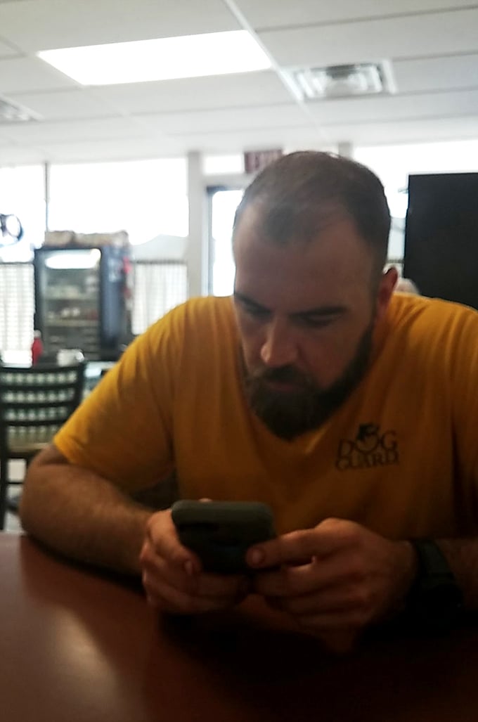 A patron enjoying a moment of contemplation before diving into Watson's legendary offerings. Some meals deserve a moment of silent appreciation.