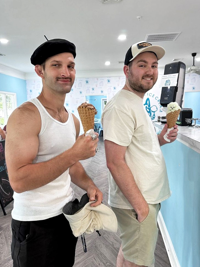 Two happy customers with cones in hand&mdash;living proof that ice cream is the universal language of joy, regardless of hat choice.